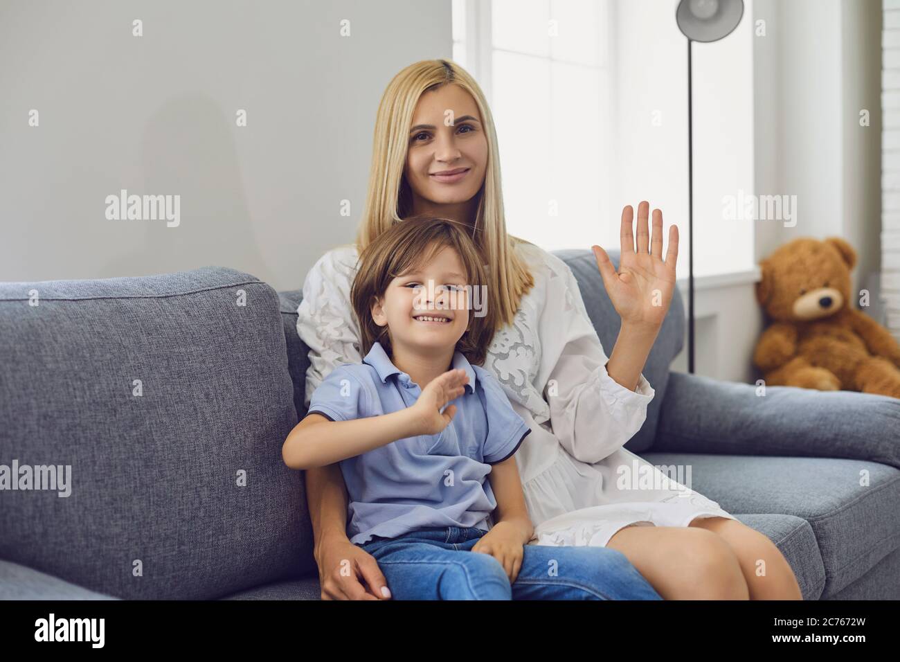 Online communication. Mother and her son talking to family from home ...