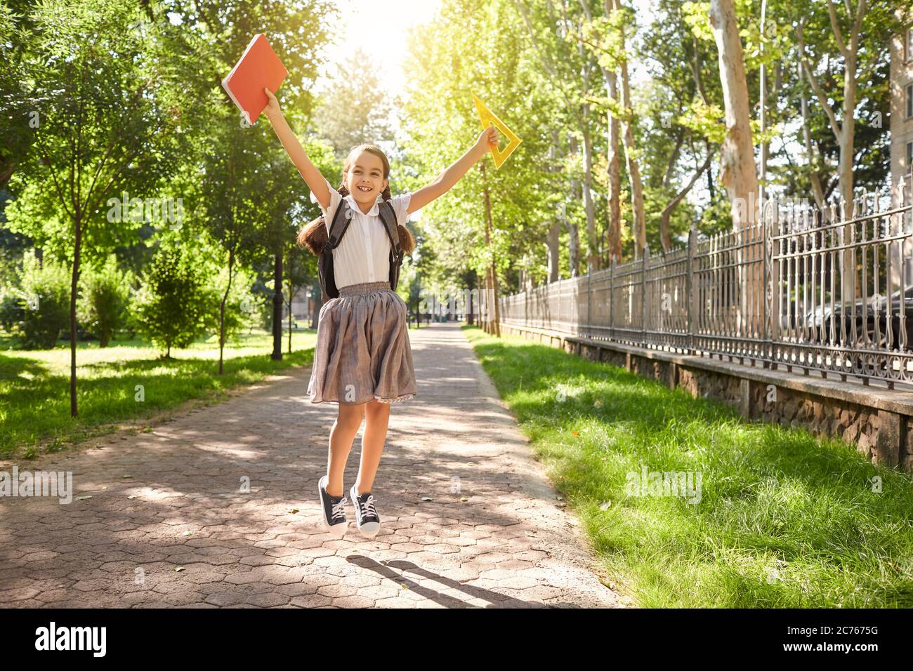 Back to school. Full length portrait of excited little schoolgirl ...