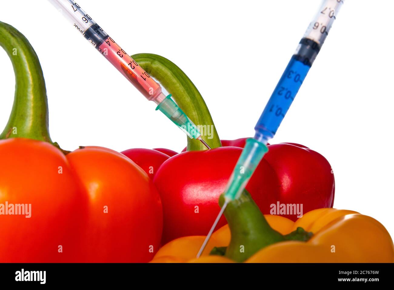 Genetically modified vegetables. GMO food concept. Syringes are stuck ...