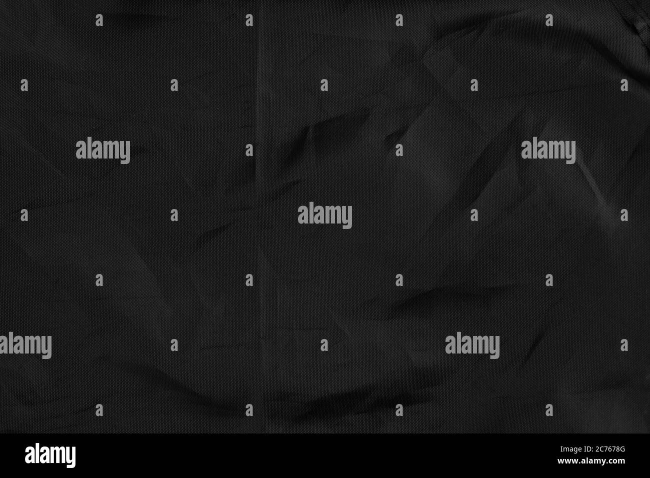 Abstract black synthetic material with wrinkles and wrinkled folds. Old ...