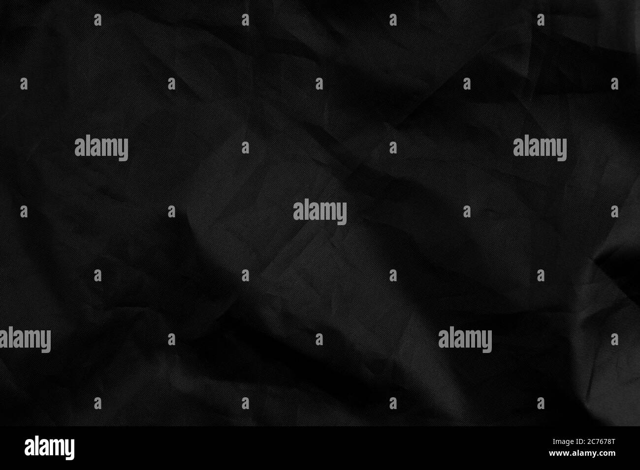 Abstract black synthetic material with wrinkles and wrinkled folds. Old ...