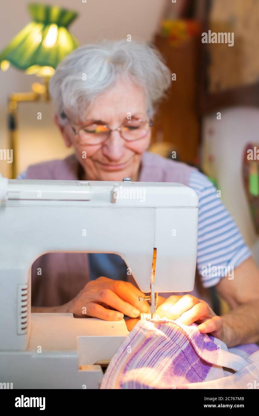 detail of an elderly woman sewing Stock Photo - Alamy