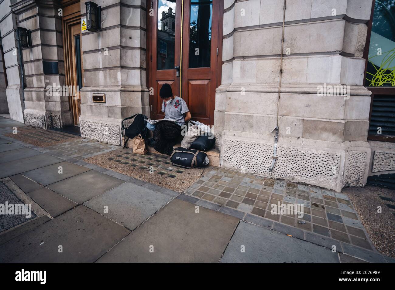 London / UK - 07/11/2020: Homeless lady sitting on the pavement ...