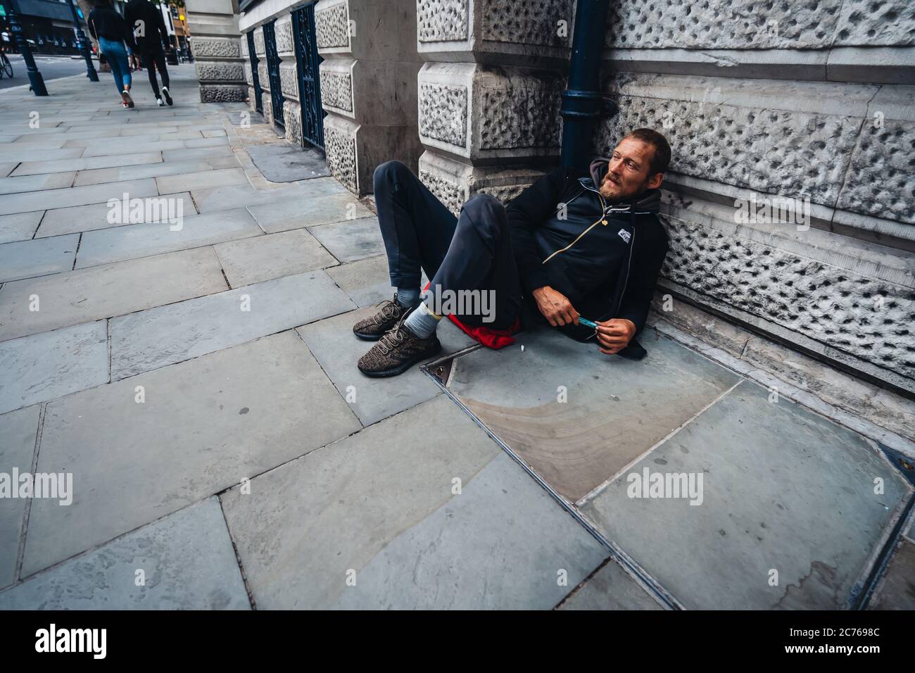 London / UK - 07/11/2020: Homeless man sitting on the pavement in ...