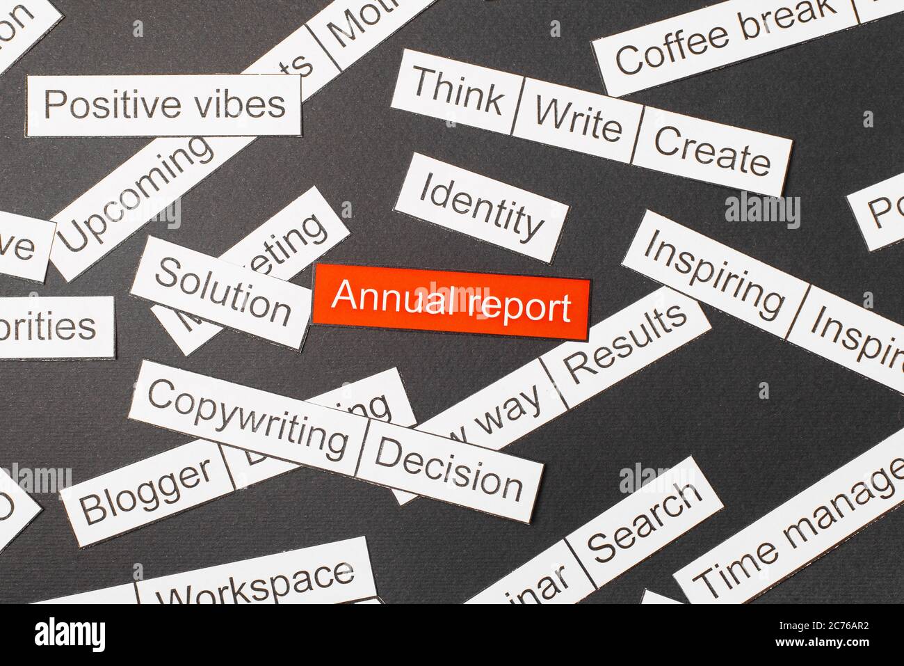 Cut paper inscription annual report on a red background, surrounded by ...