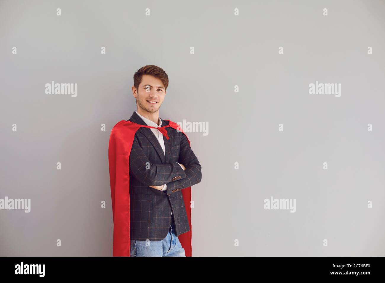 Happy man in superhero costume smile on gray background Stock Photo - Alamy