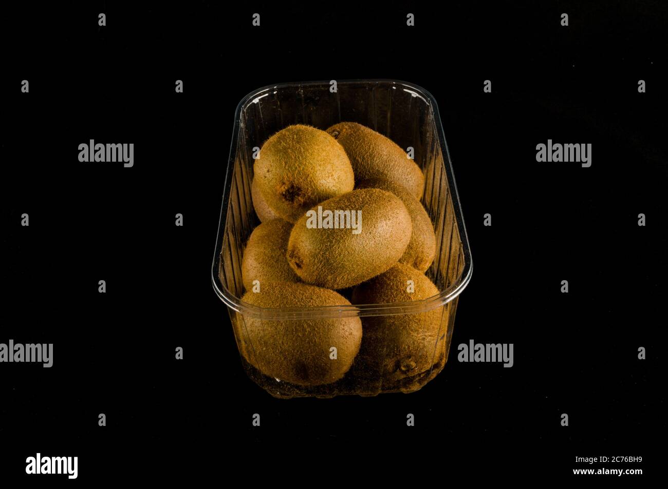 Kiwi in a box isolated on black background Stock Photo - Alamy