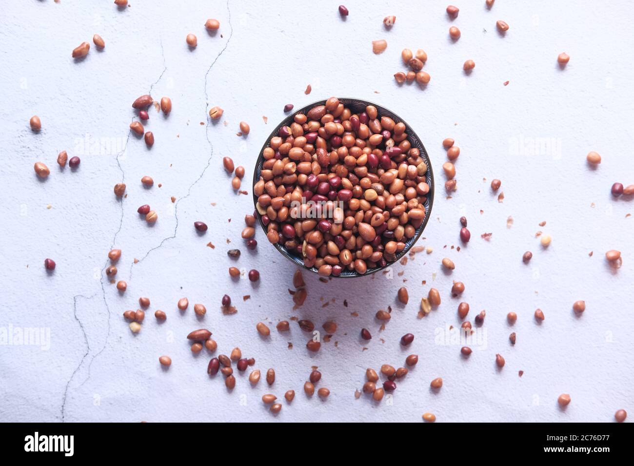 Processed pea nuts in a bowl on table top down Stock Photo - Alamy
