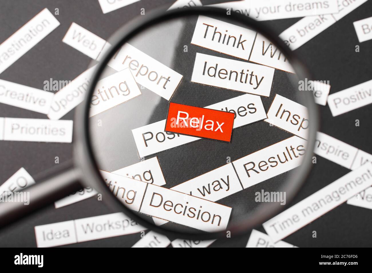 Magnifier glass over the red inscription relax cut out of paper ...