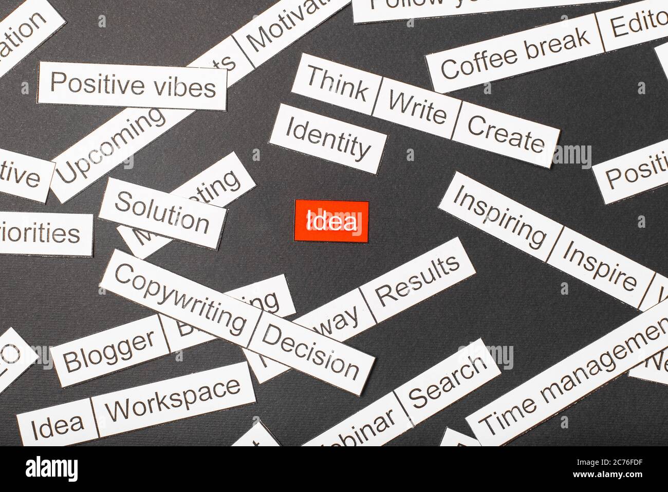 Cut paper inscription idea on a red background, surrounded by other ...