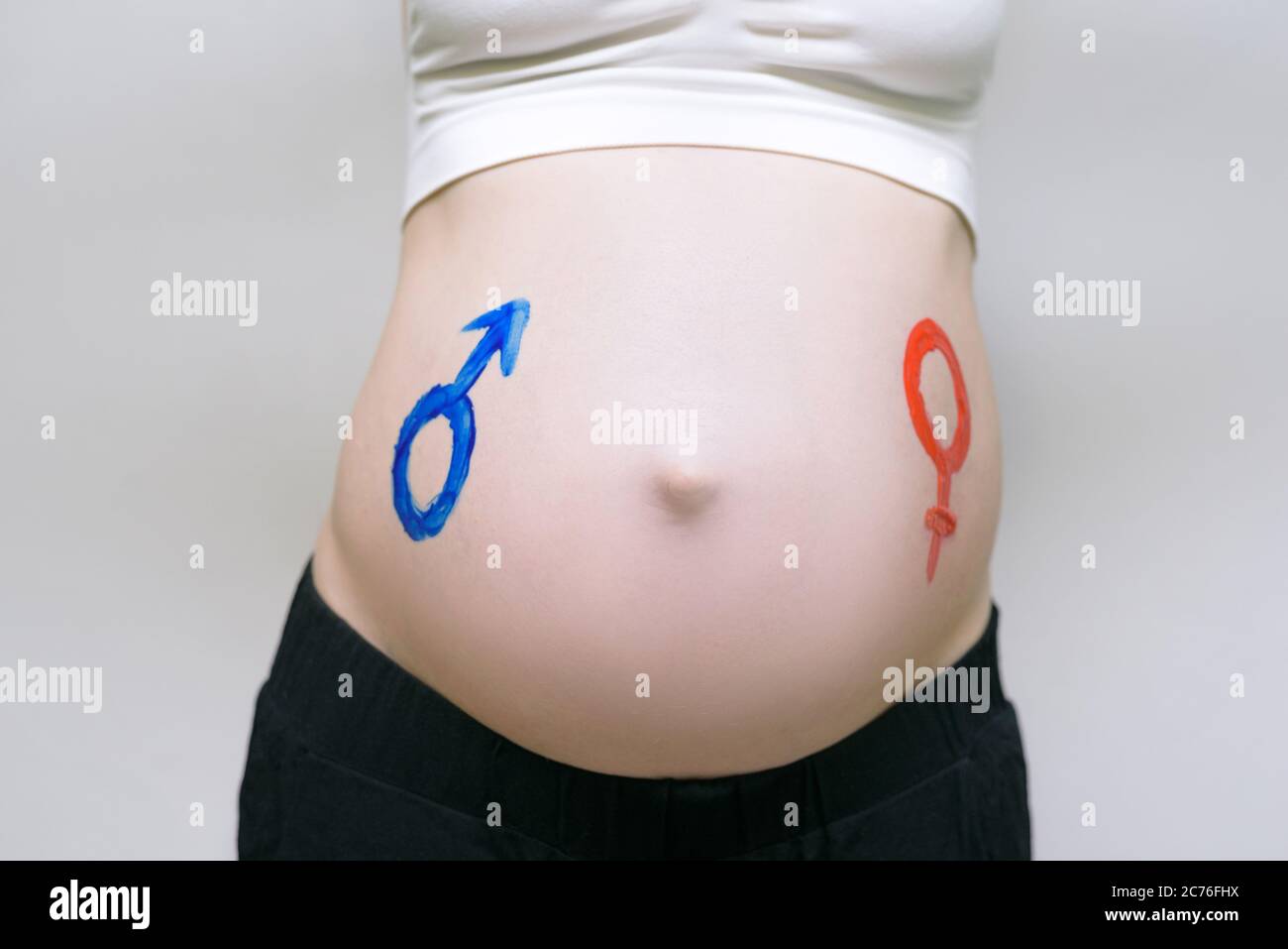 Gender symbols drawn on a pregnant female belly. Pregnant concept ...
