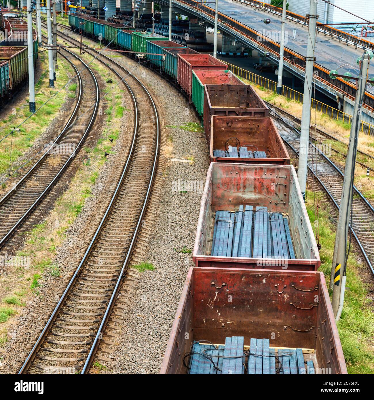 Train with cargo wagons on the railroad Stock Photo - Alamy