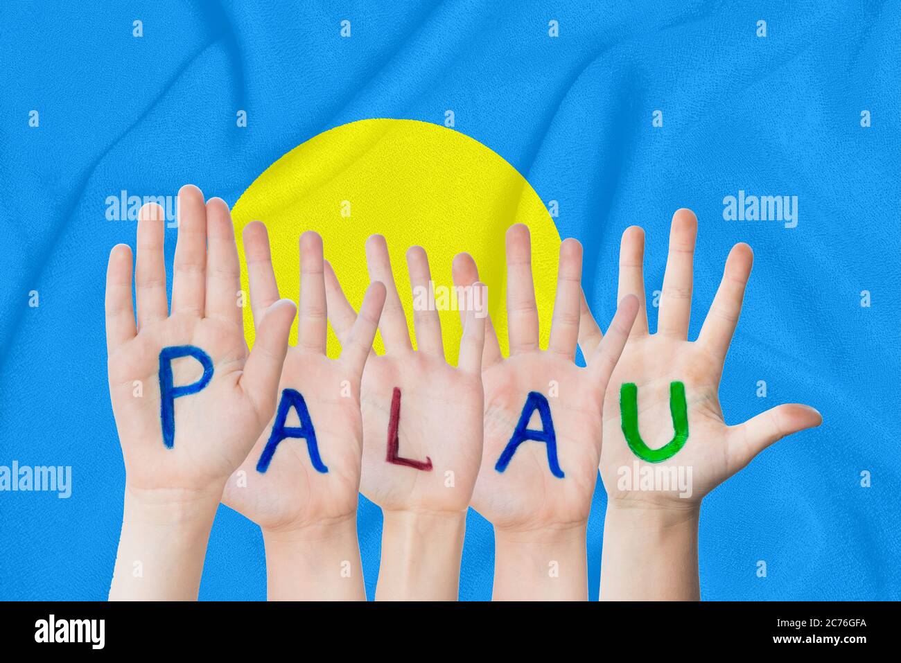 Inscription Palau on the children's hands against the background of a ...
