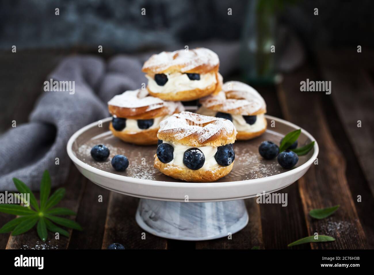 Cream puff rings (choux pastry) decorated with fresh blueberries Stock ...