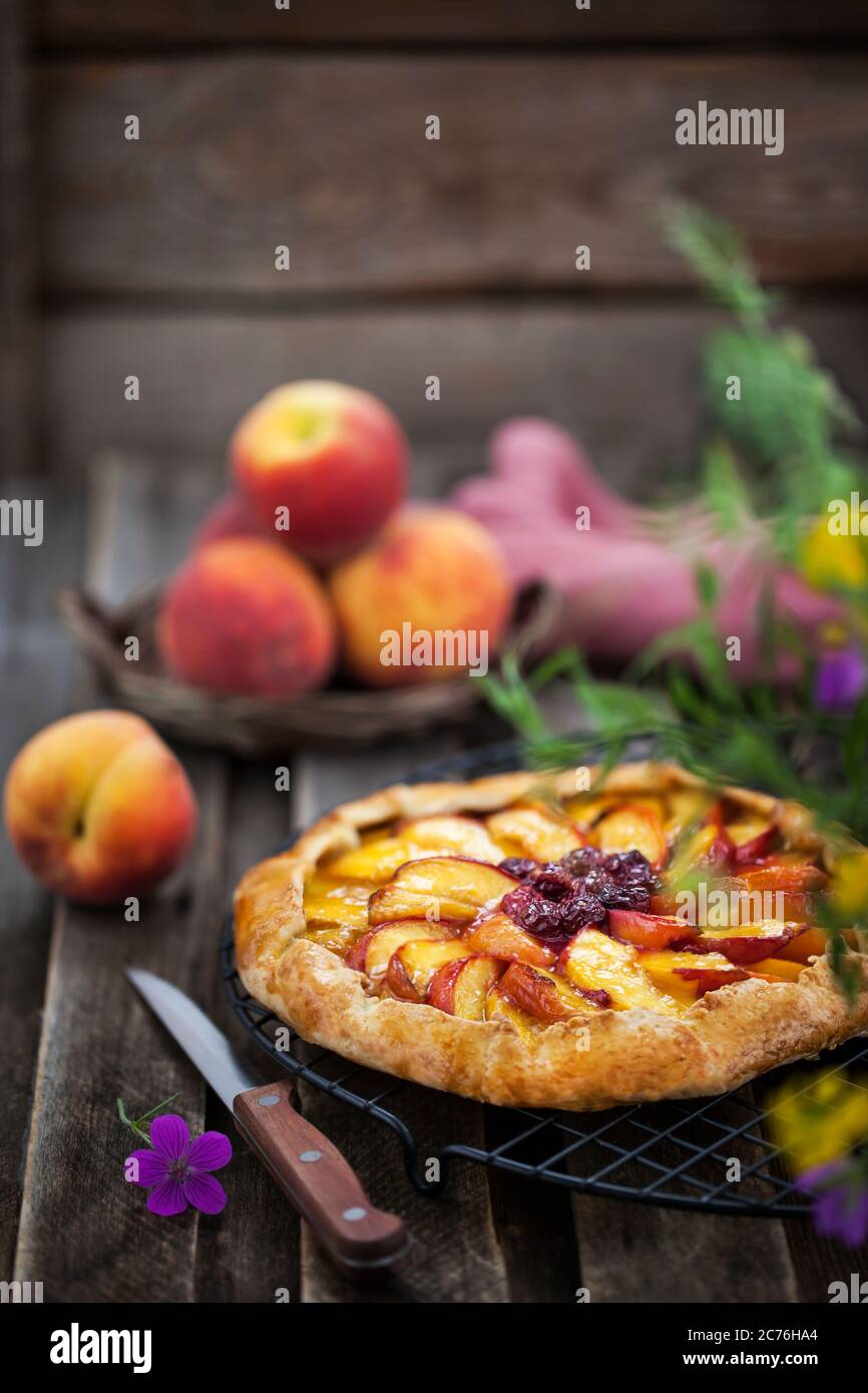 Rustic open pie (galette) with peach and cherry Stock Photo - Alamy