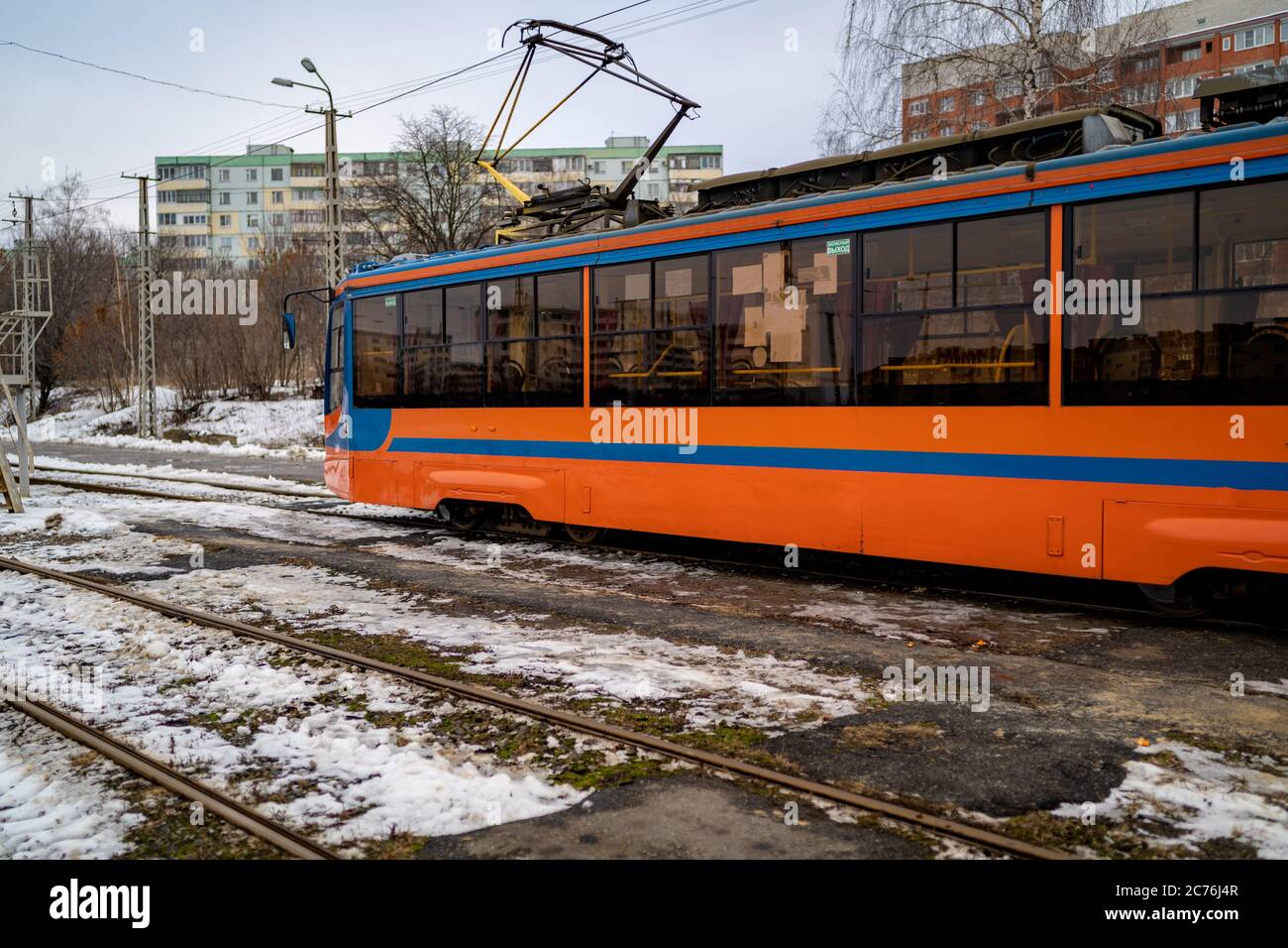 Modern tram in winter city. Contemporary tram is on tram station in ...