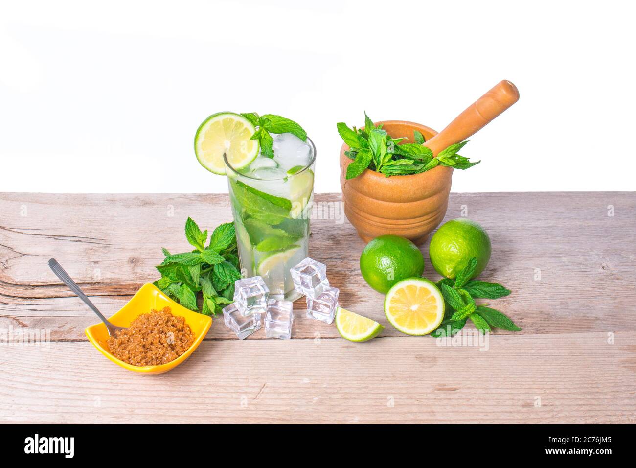 Mojito cocktail with ingredients. Fresh lime, mint leaves and ice cubes ...