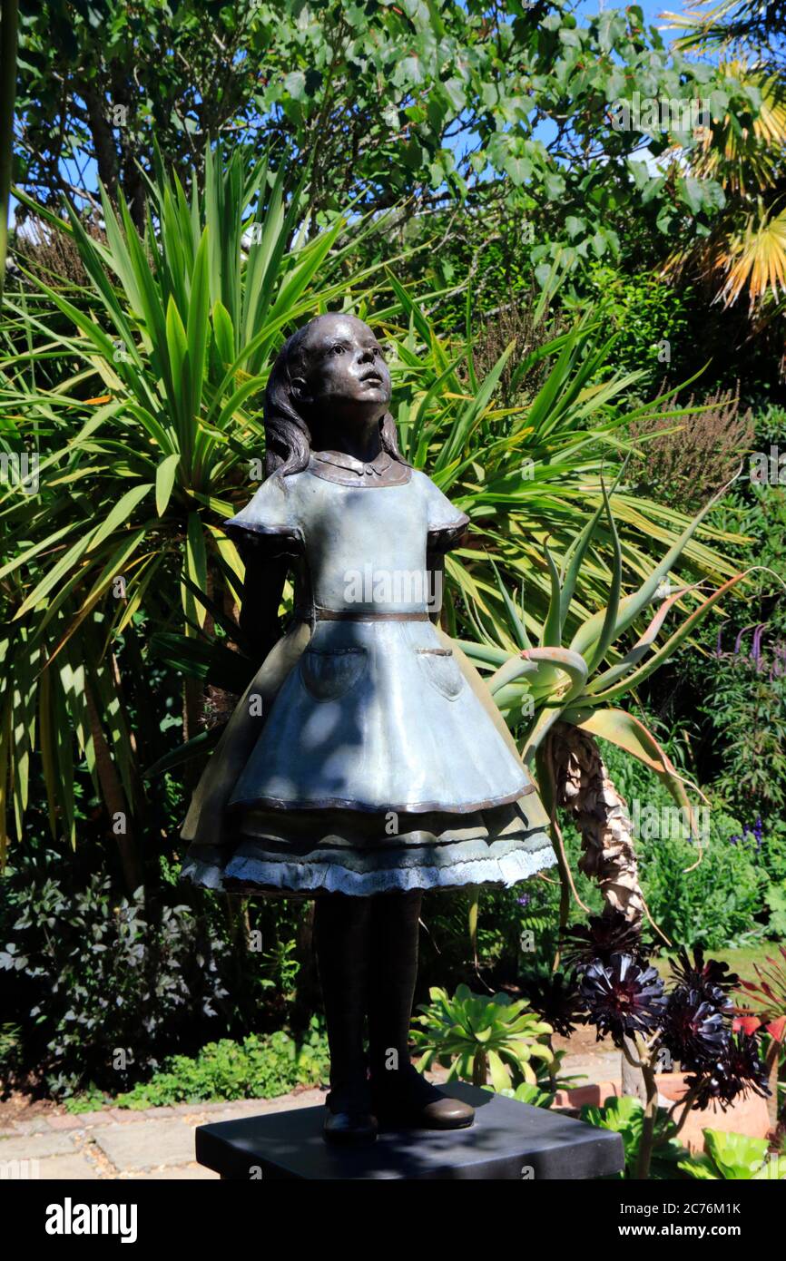 A statue of Alice in Wonderland at Abbotsbury sub tropical gardens in ...