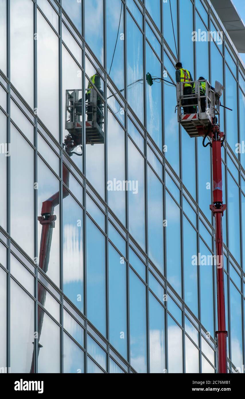 Window cleaner, building maintenance, facade cleaning, on an elevating ...