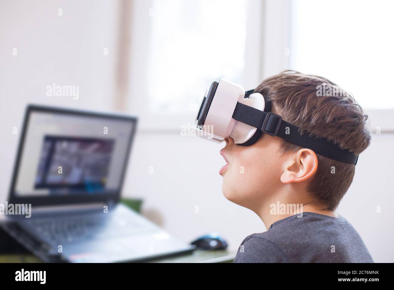 young boy looking through VR goggles Stock Photo - Alamy