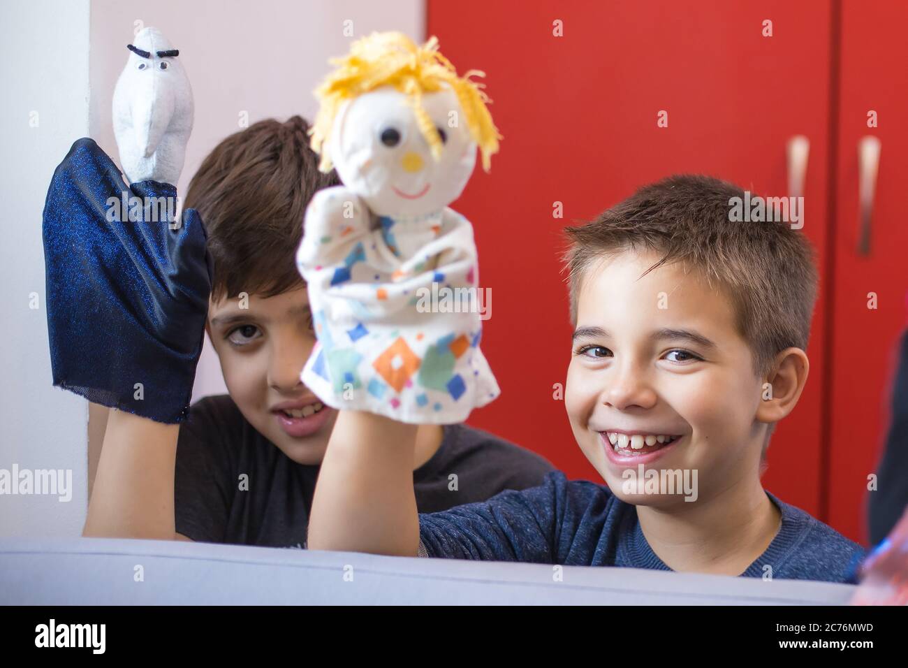 two little boys playing with puppets Stock Photo - Alamy
