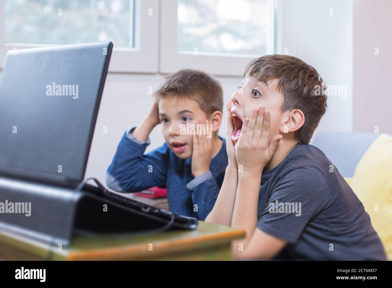 Two boys using laptop school hi-res stock photography and images - Alamy