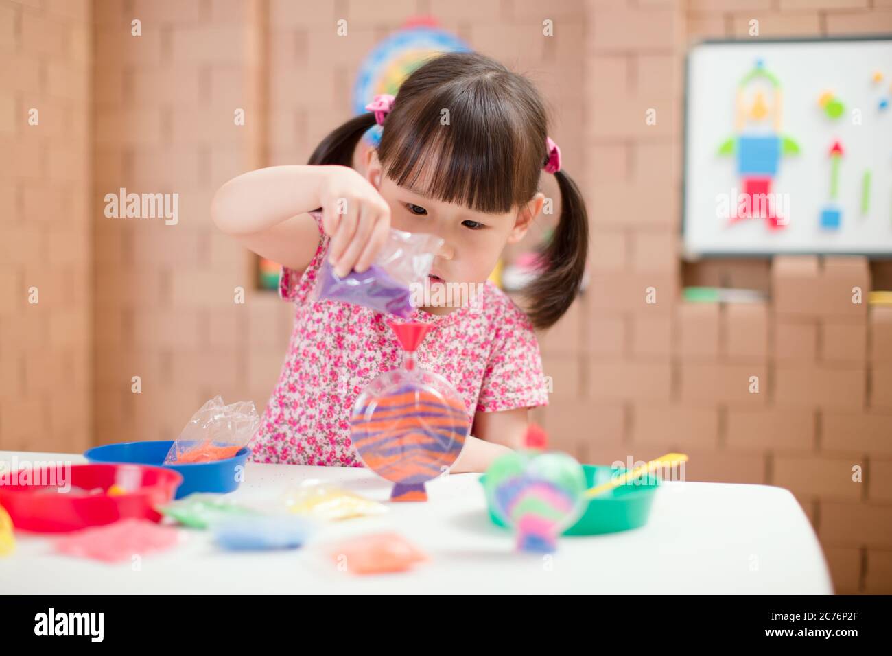 toddler girl making sand animal crafts for homeschooling Stock Photo ...