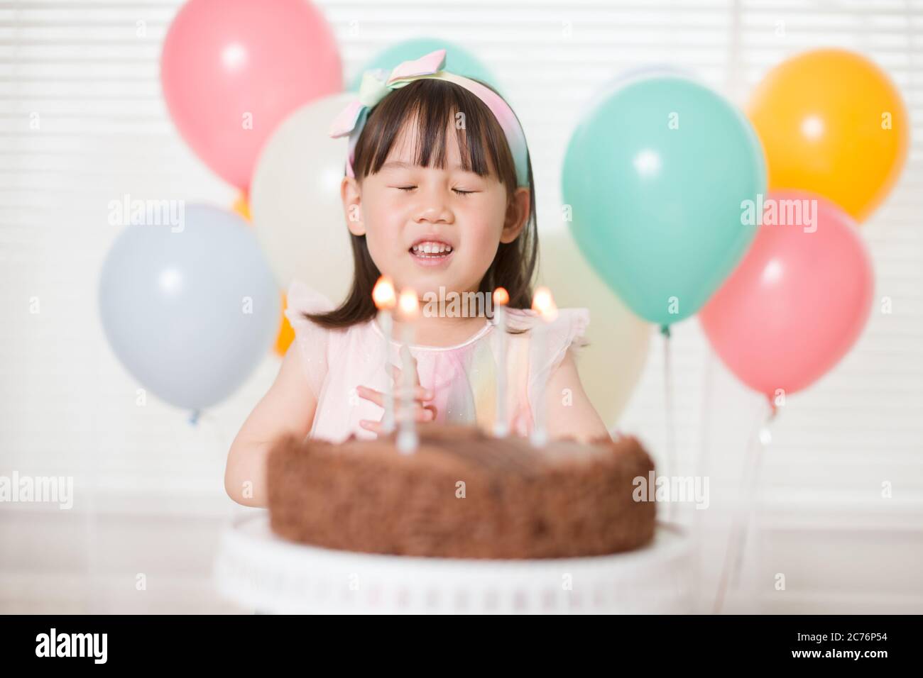 toddler girl make a wish for celebrating her 4th years birthday Stock ...