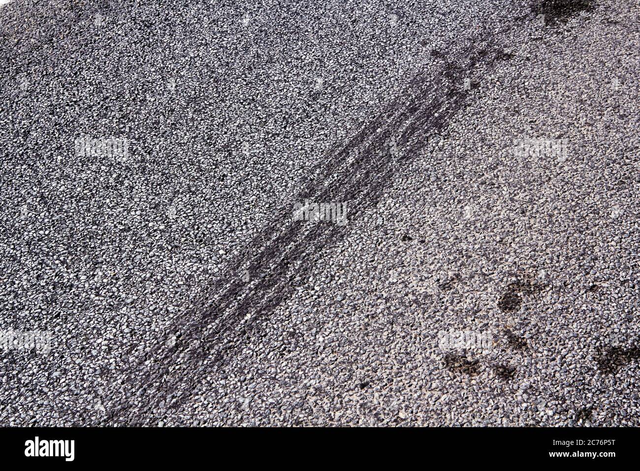 Tire tracks on a asphalt road, abstract background Stock Photo - Alamy