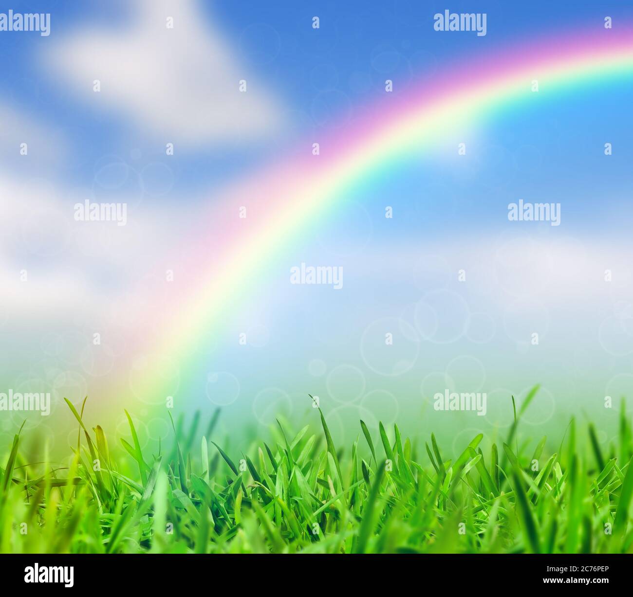 Green grass and blue sky with a rainbow, spring nature background Stock ...