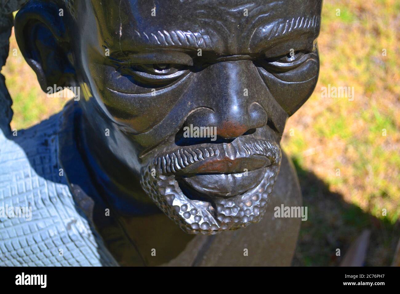 Black statue of a male face Stock Photo - Alamy