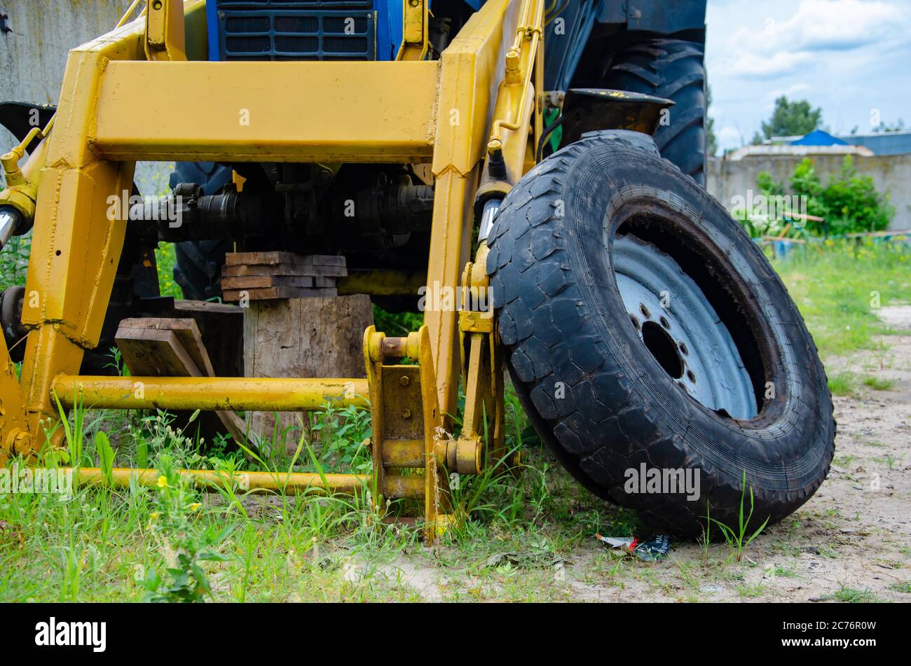 Old rusty tractor's flat back tire Stock Photo - Alamy