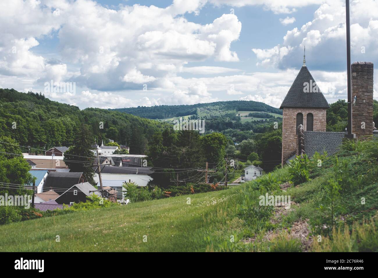 An old school overlooks rolling green hills and a small town in rural ...