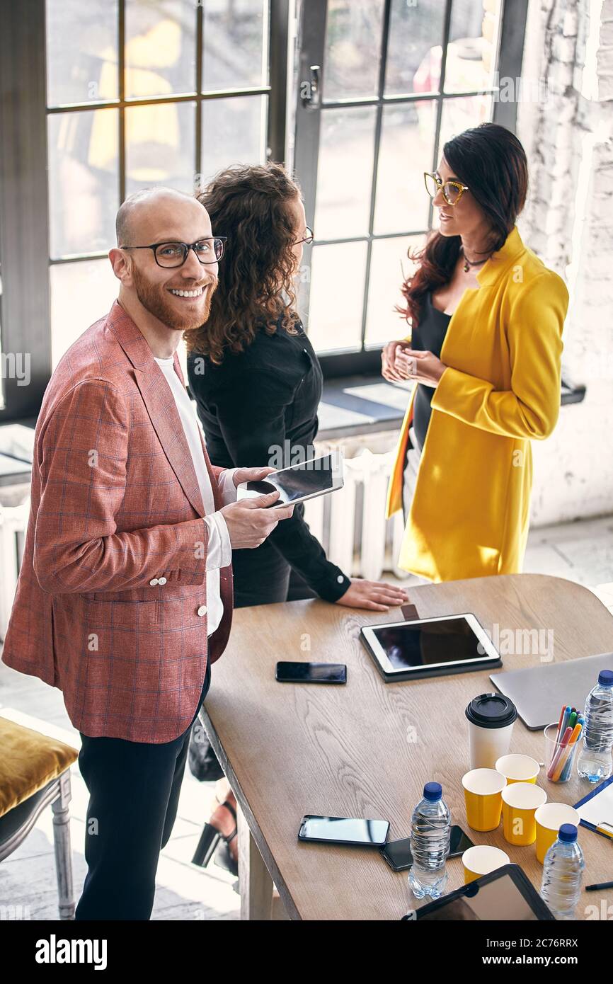 Happy colleagues having fun during working process collaborating in ...