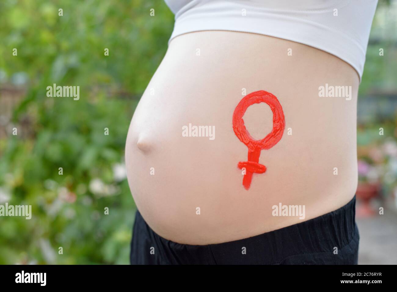 Gender female symbol drawn on a pregnant female belly. Pregnant concept ...