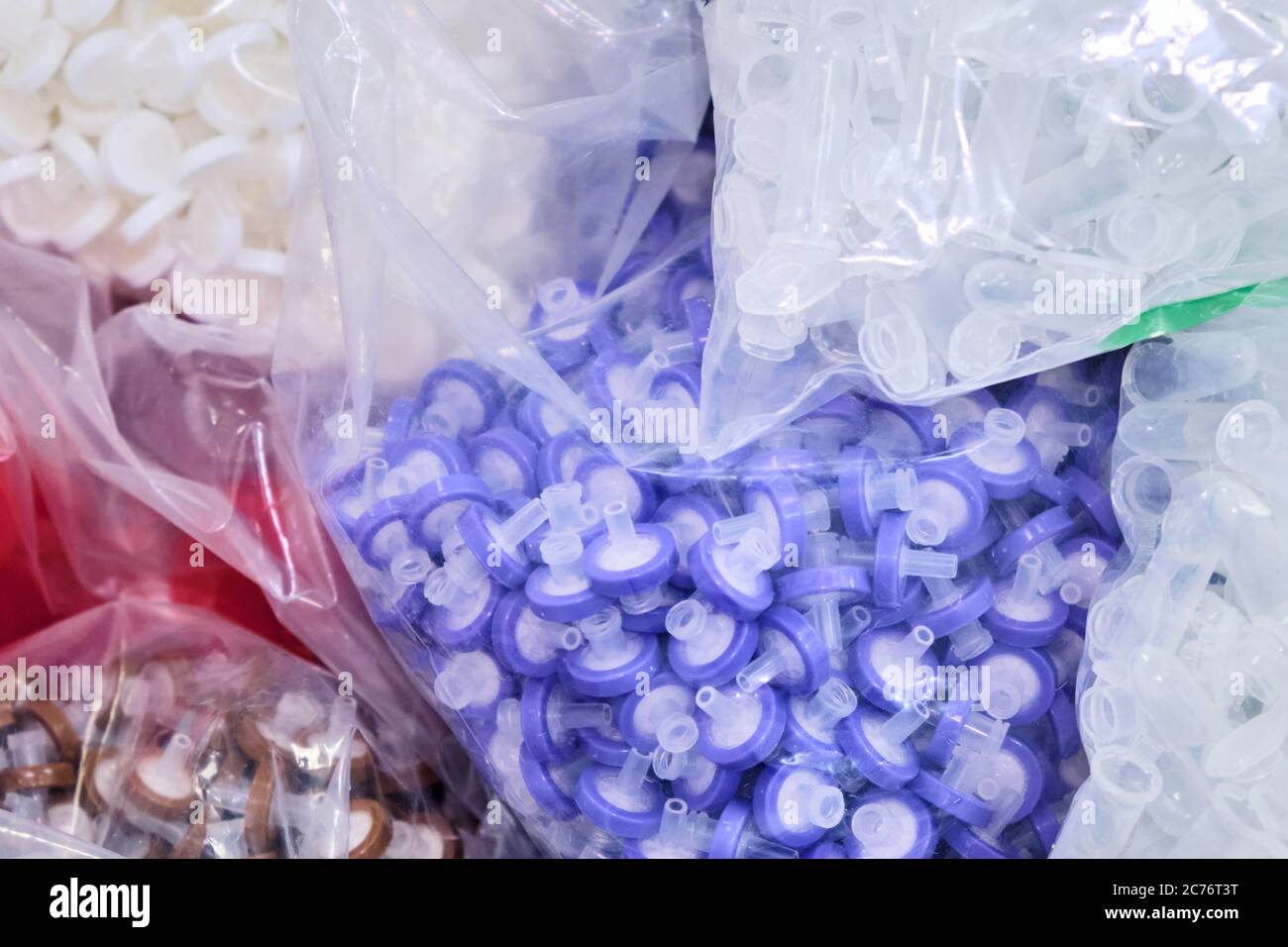 Purple, brown, white membrane filters and small plastic tubes for ...