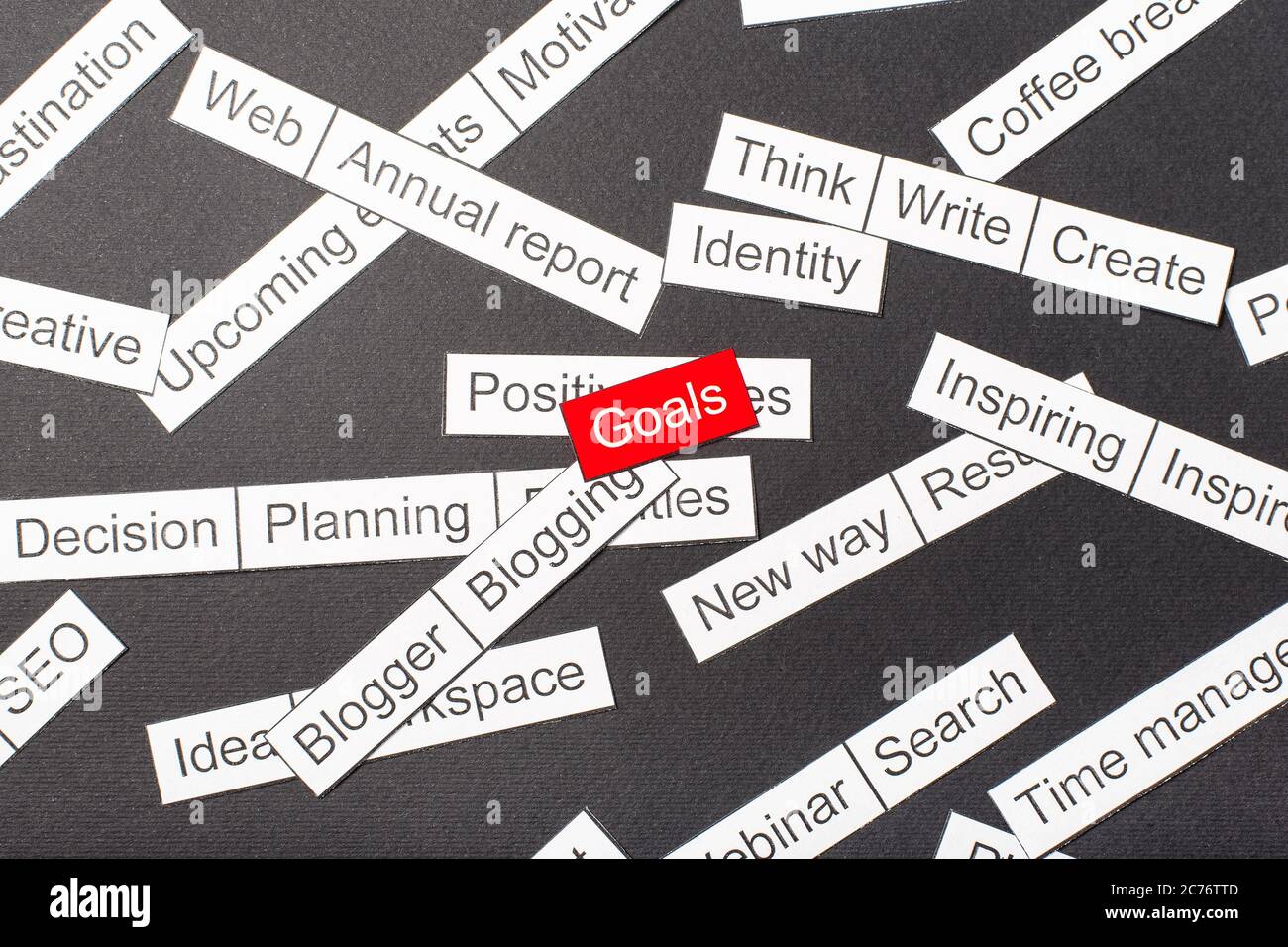 Cut paper inscription goals on a red background, surrounded by other ...