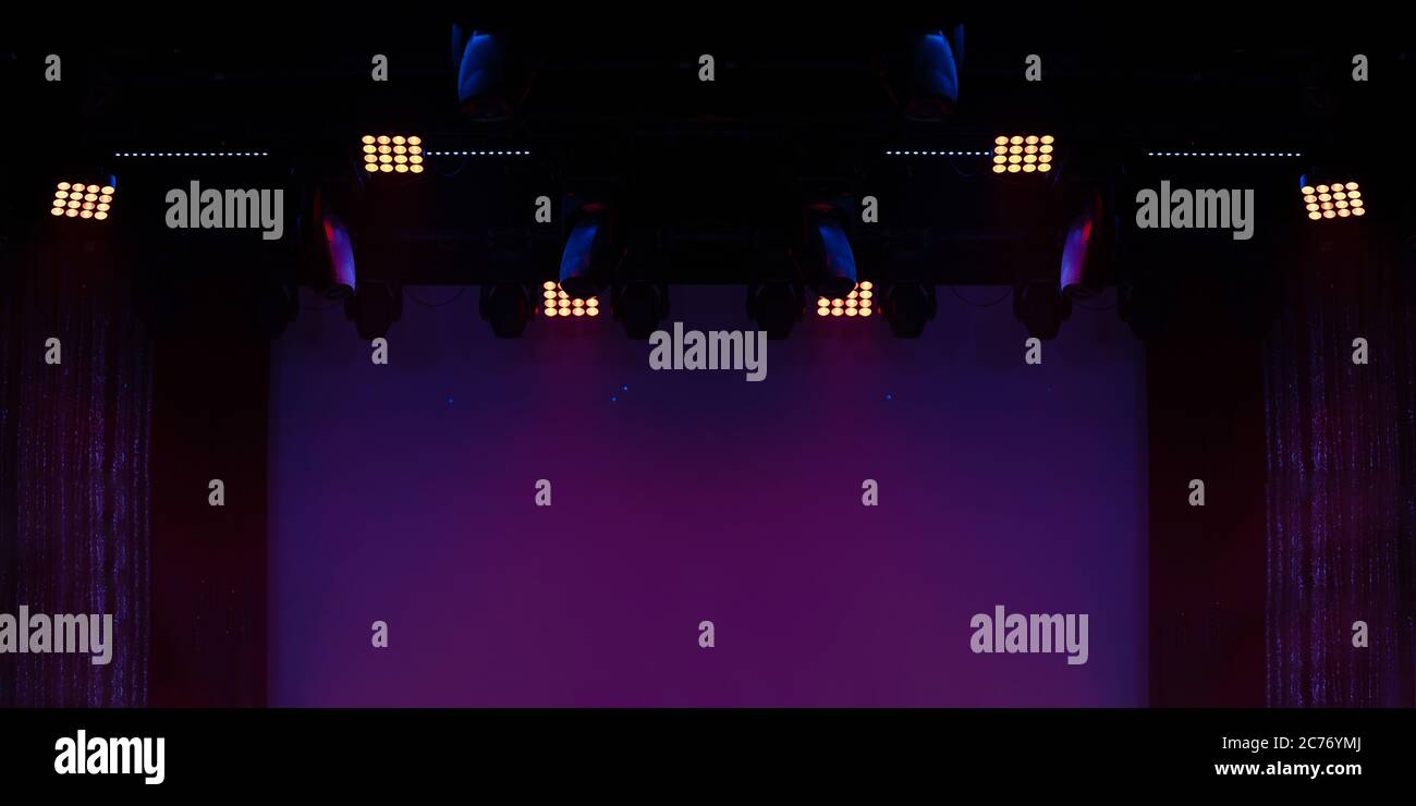 An empty stage of the theater, lit by spotlights and smoke before the ...