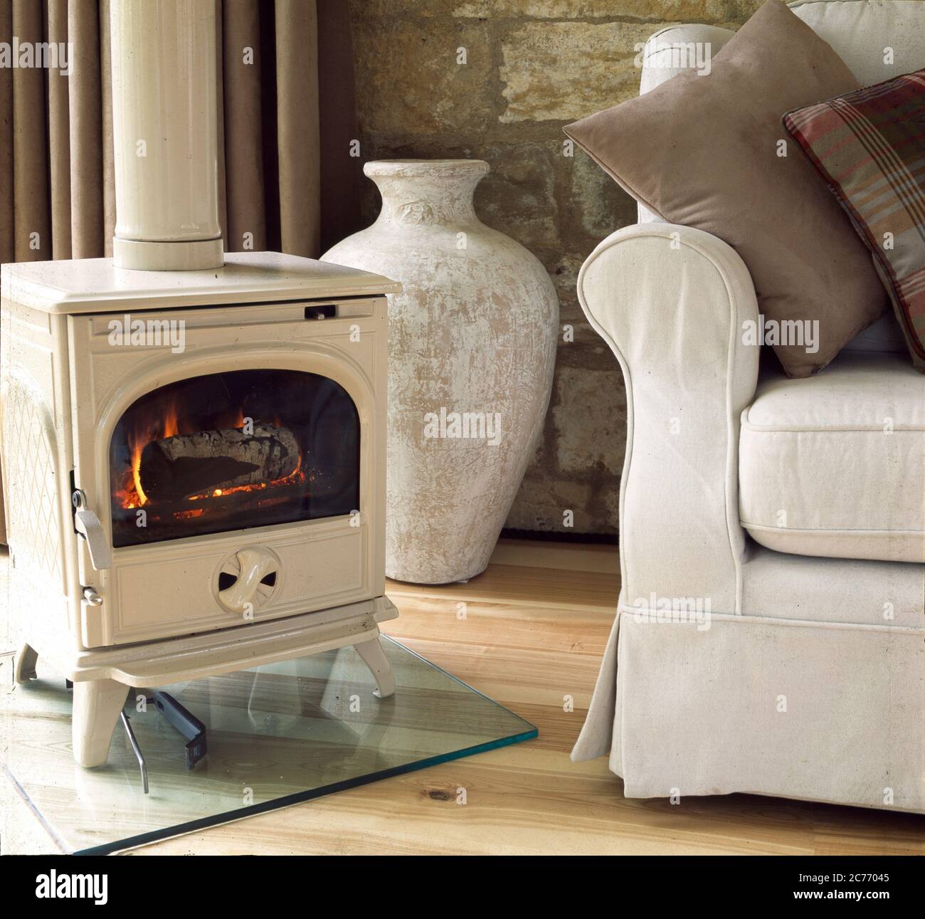 Woodburner in corner of living room Stock Photo - Alamy