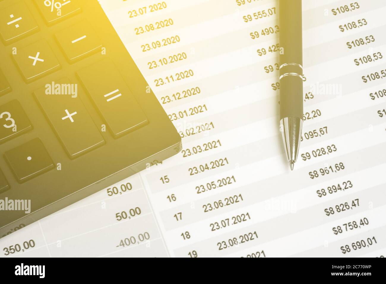 Pen and calculator close-up on financial papers. Statistical table with ...