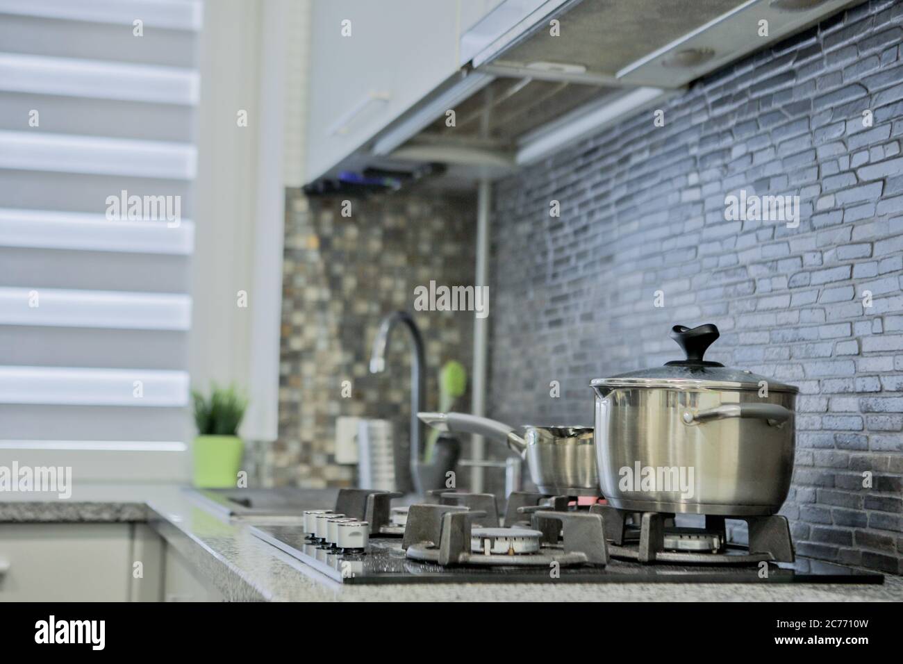 pan on the stove in kitchen interior home Stock Photo - Alamy