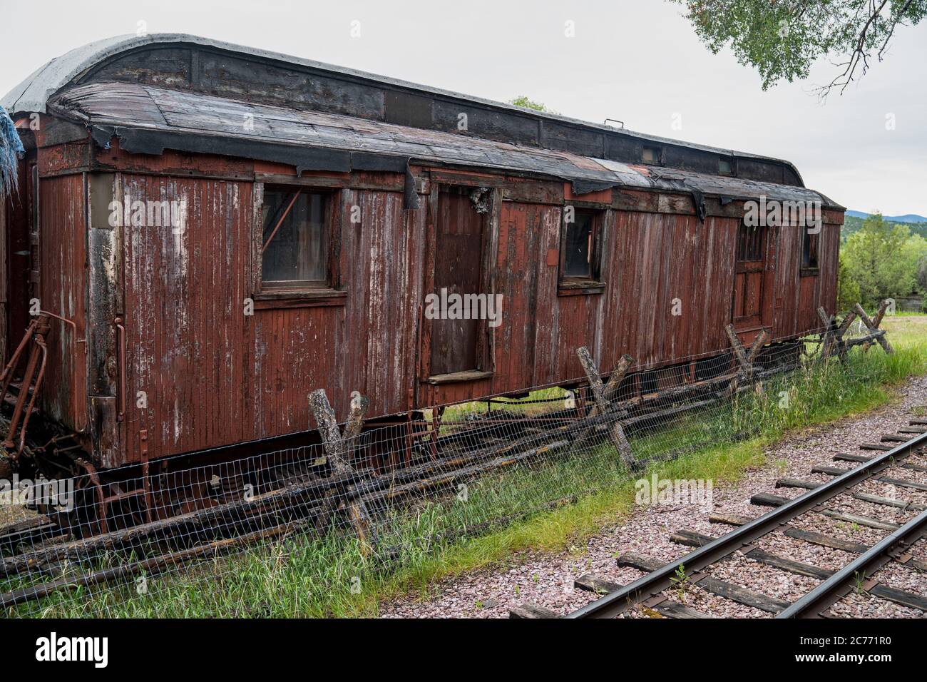 Old abandoned red boxcar train car on the railroad tracks in the ghost ...
