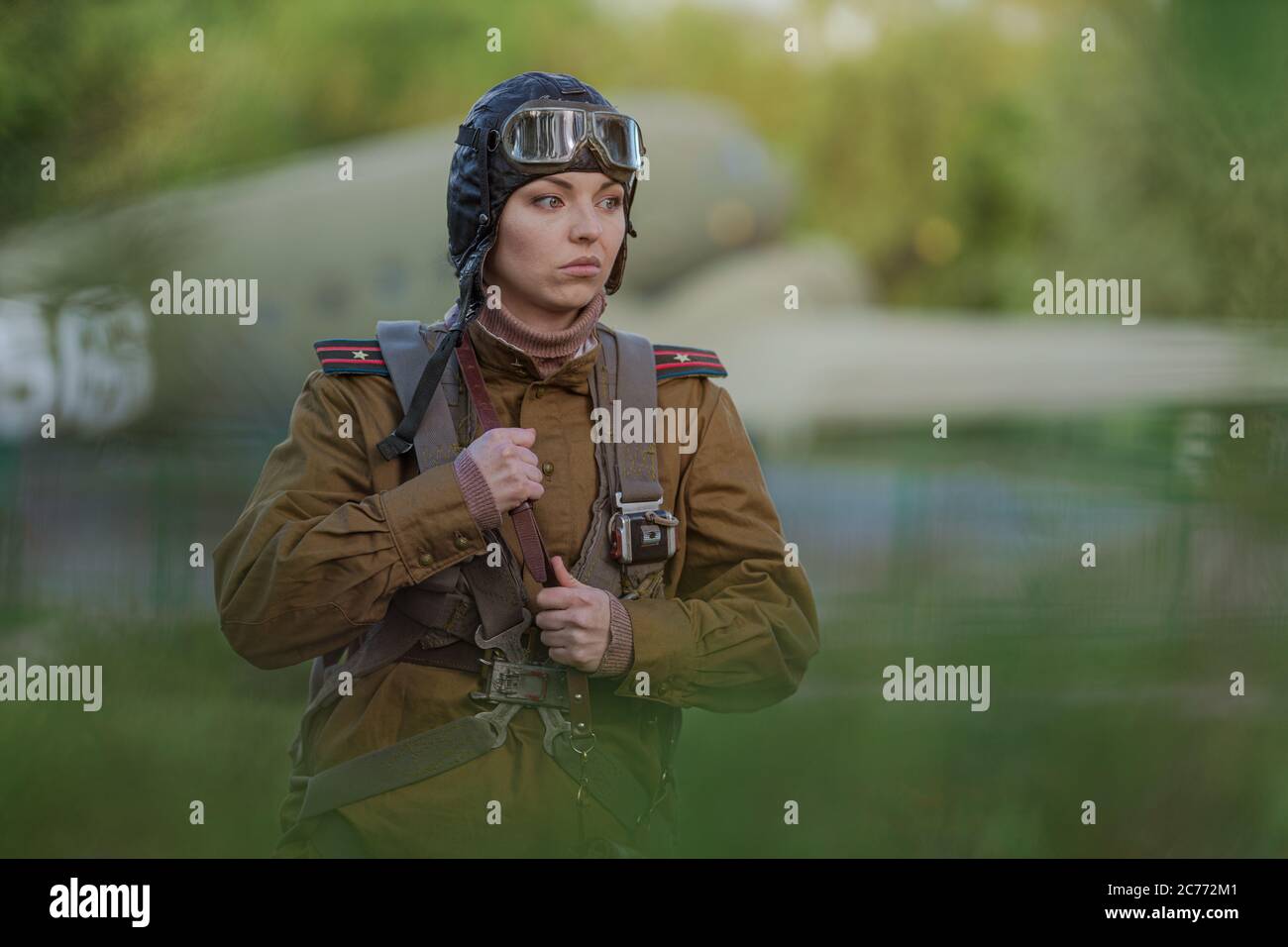 A young female pilot in uniform of Soviet Army pilots during the World ...