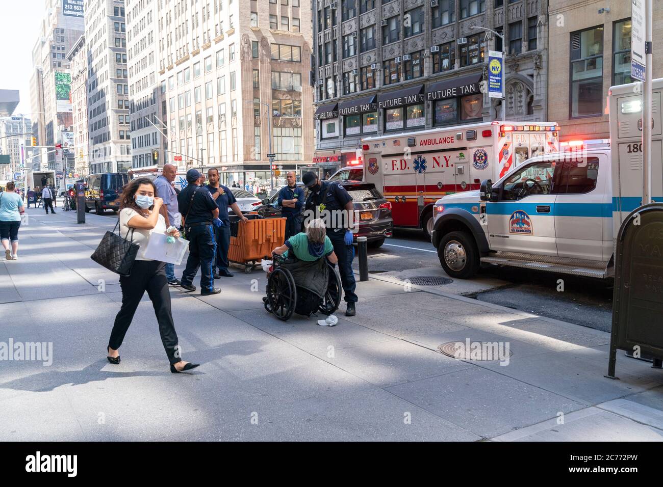 New York, NY - July 14, 2020: Paramedics attend sick homeless man as ...