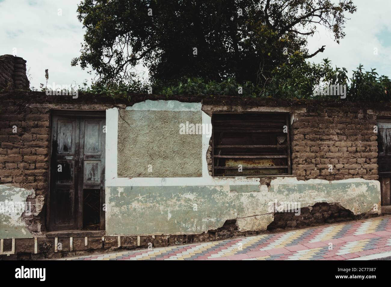 very old house facade falling apart, rural village Stock Photo - Alamy