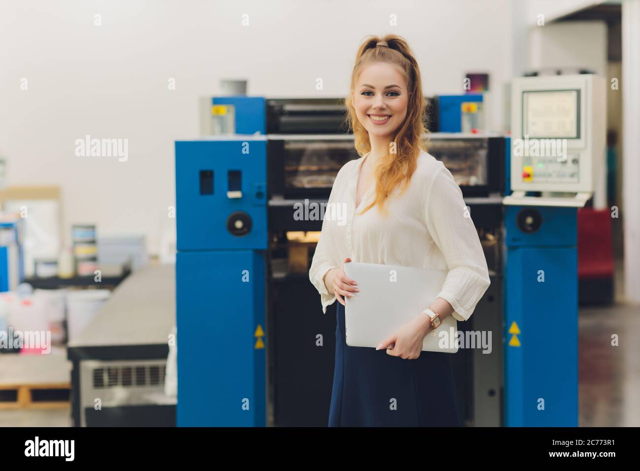 Young woman working in printing factory. Printing Press Stock Photo - Alamy