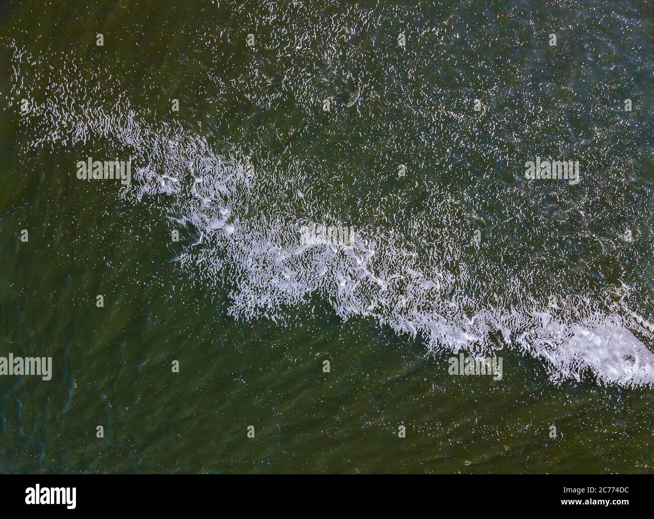Blue wave water view from height to the shining and sparkling sea ...