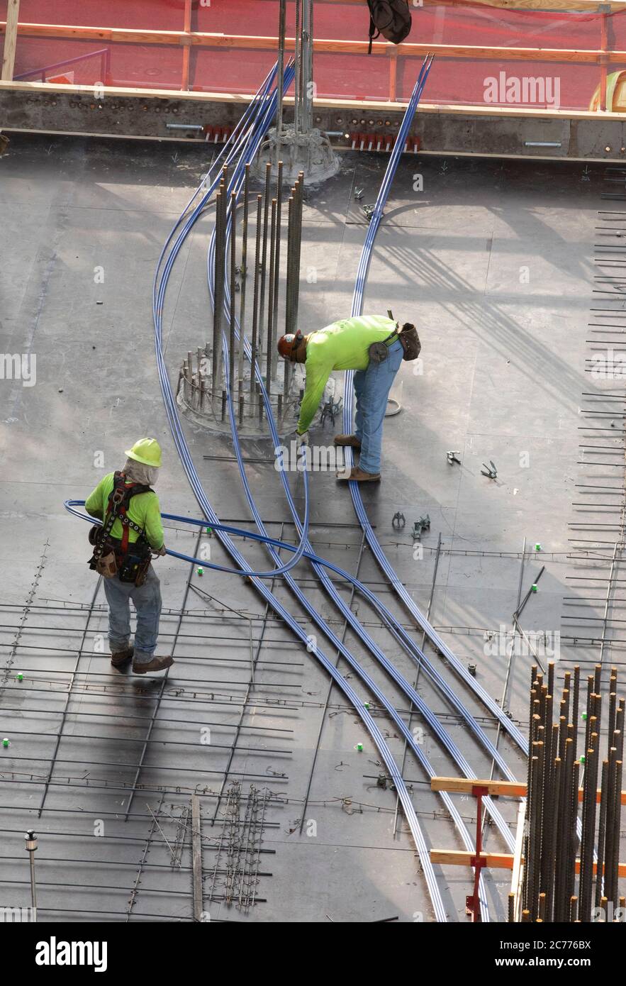 Construction workers and concrete specialists at work on the lower ...