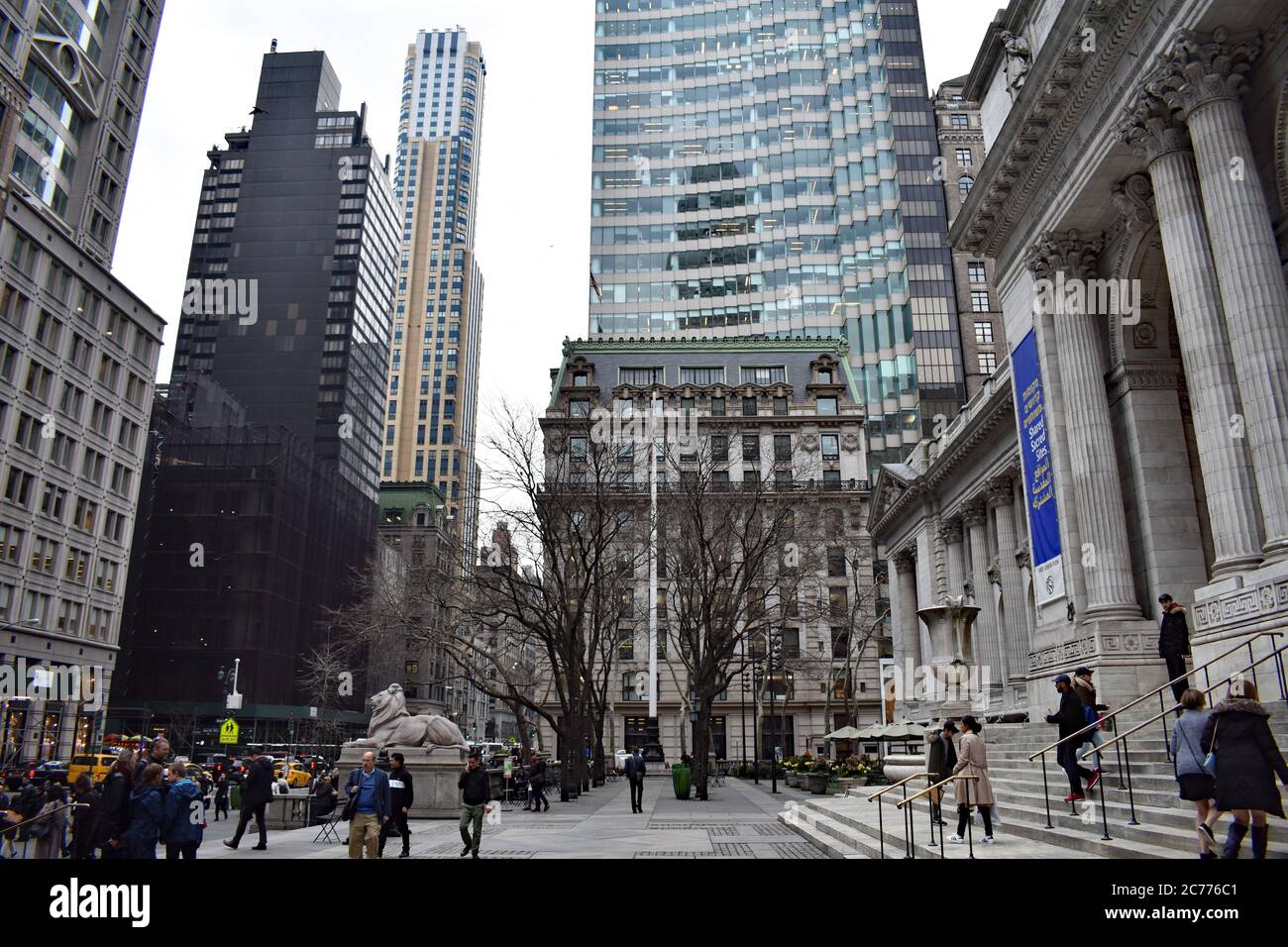 Visitors on the steps outside the New York Public Library. Fifth Avenue ...