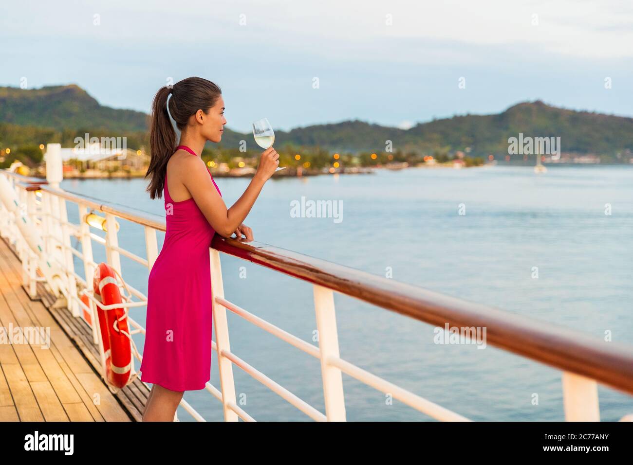 Luxury cruise ship honeymoon vacation woman drinking wine during dinner ...
